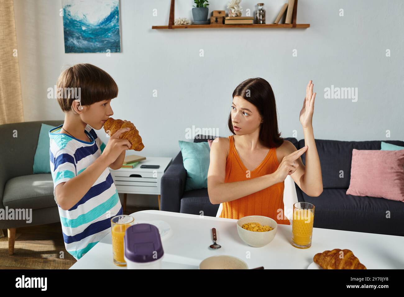 A mother uses sign language to communicate with her son while enjoying ...