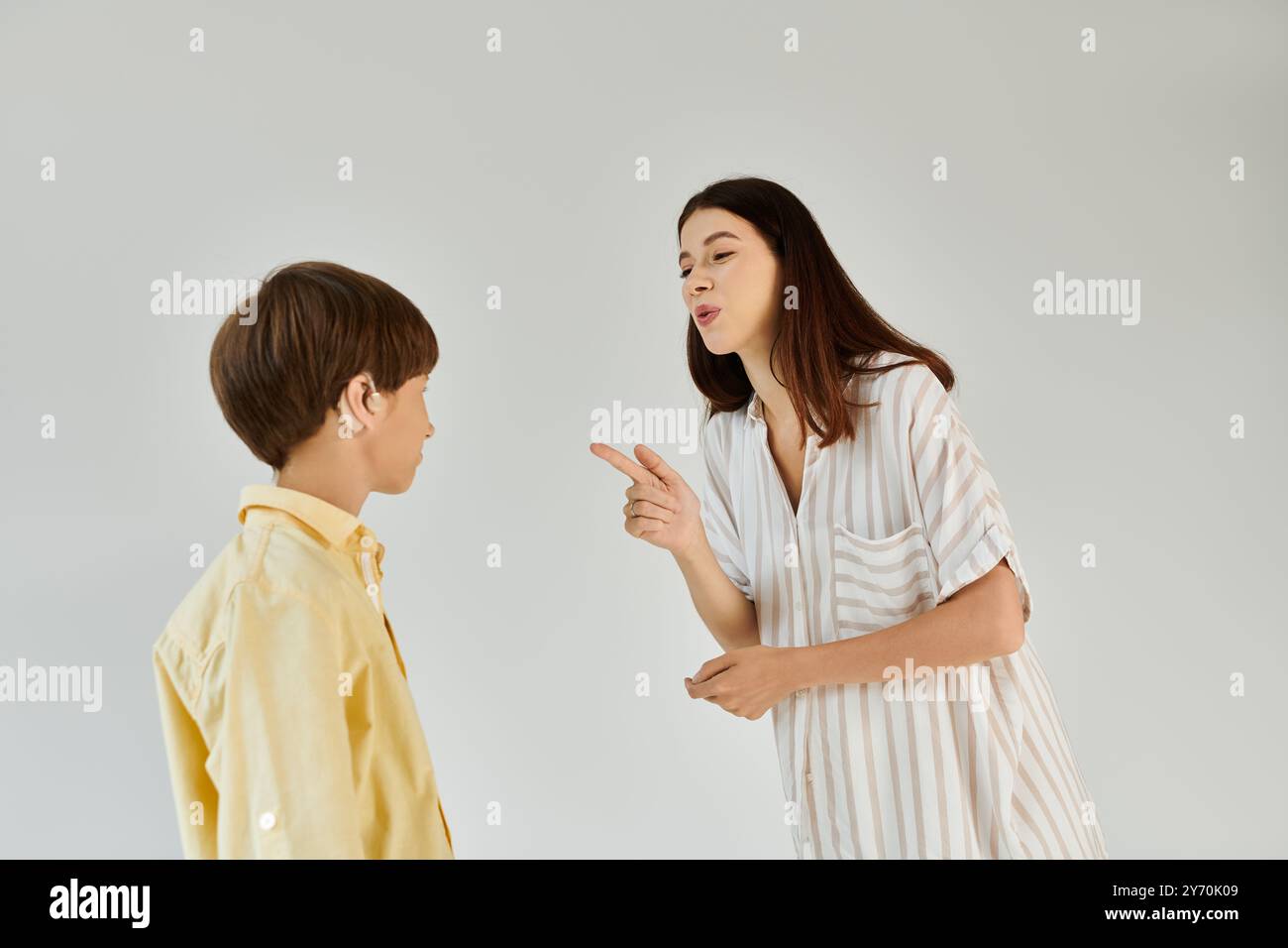 A mother engages with her son, helping him understand through gentle ...