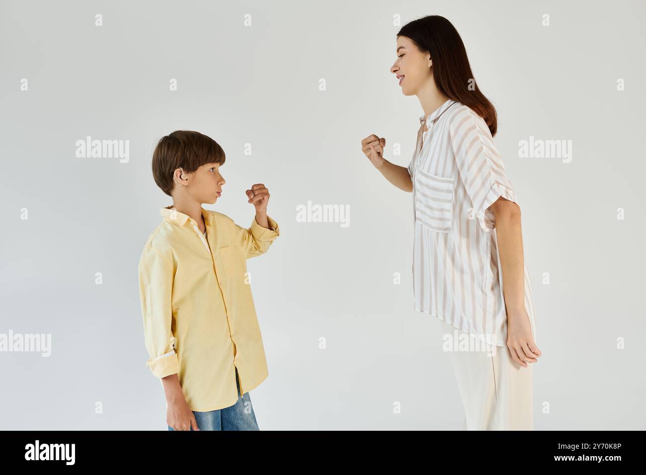 A young boy with hearing impairment learns sign language from his ...
