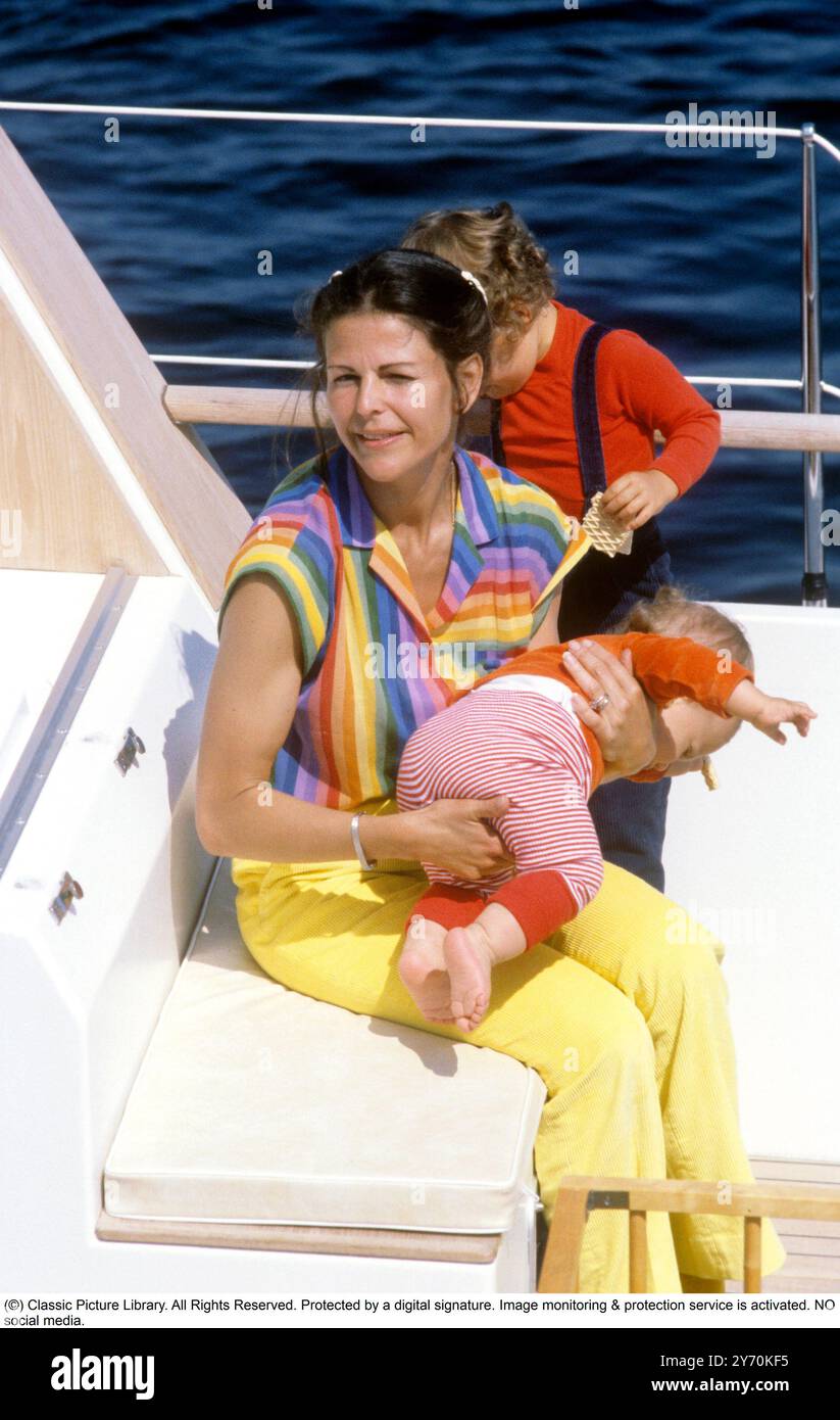 Queen Silvia of Sweden with her son prince Carl Philip in her lap on ...