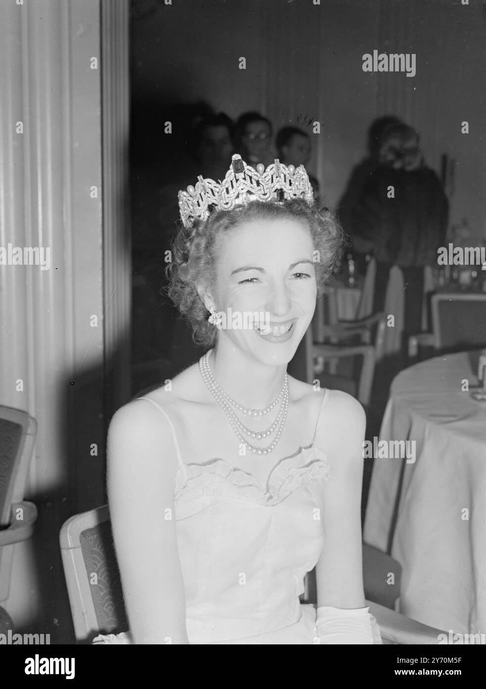 SHE STEPPED TO THE ' THRONE ' Wearing her new crown and a regal smile ...