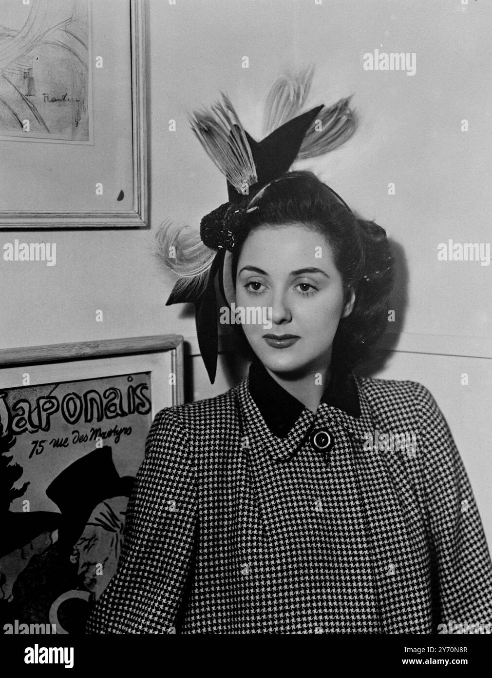 Original caption FEATHERS AND BOWS Film actress Lana Morris, pictured ...