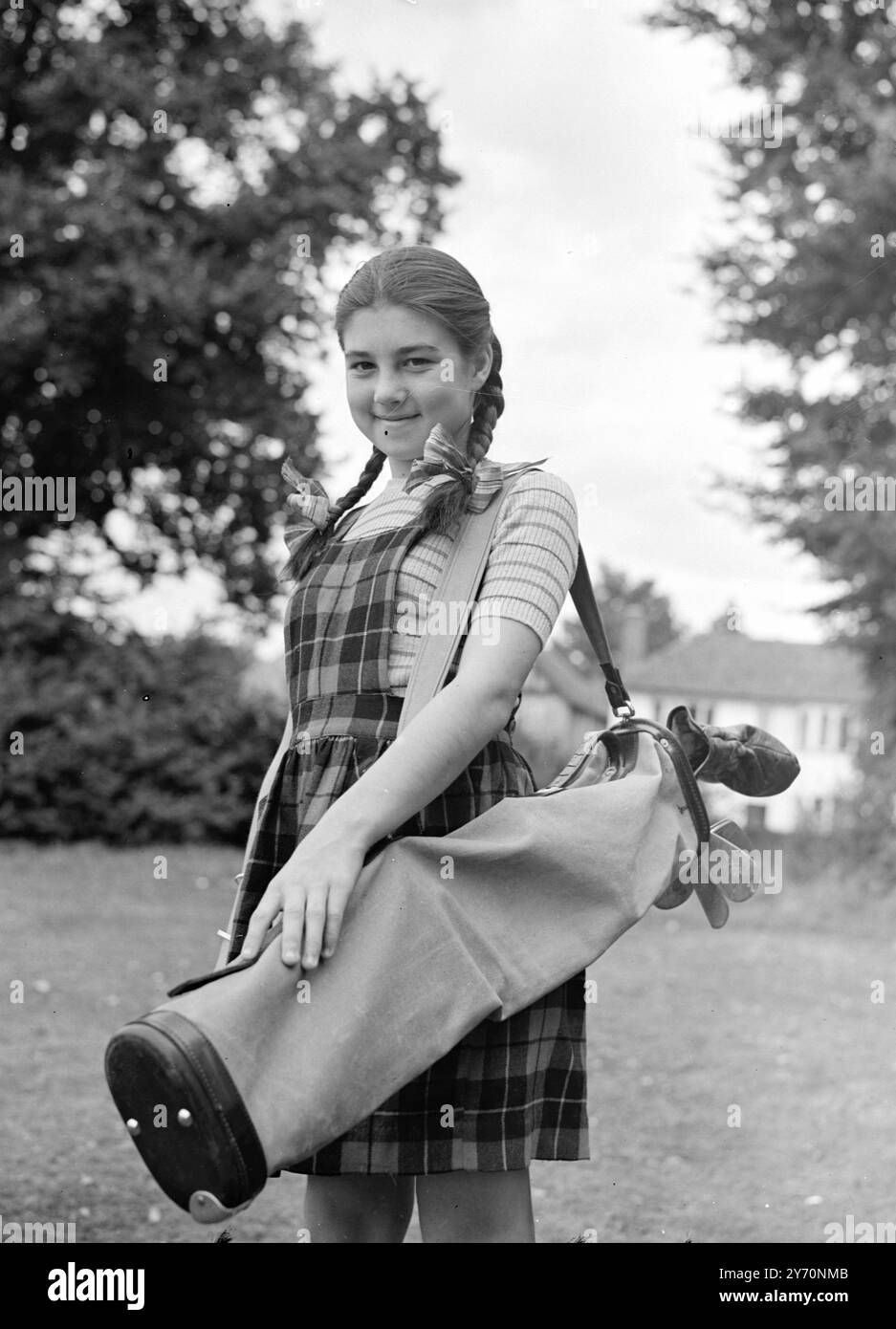 YOUNG COMPETITOR IN GOLF CHAMPIONSHIP Girl wearing a smile as she ...