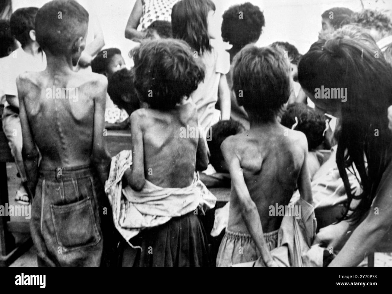 Authorities examine the crying starving children taken from an ...