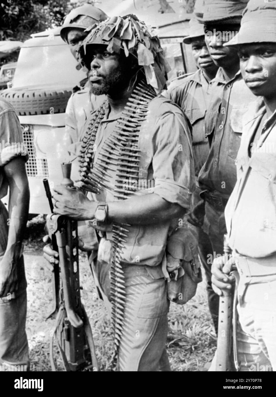 A heavily armed Nigerian Federal soldier with colleagues near the front ...