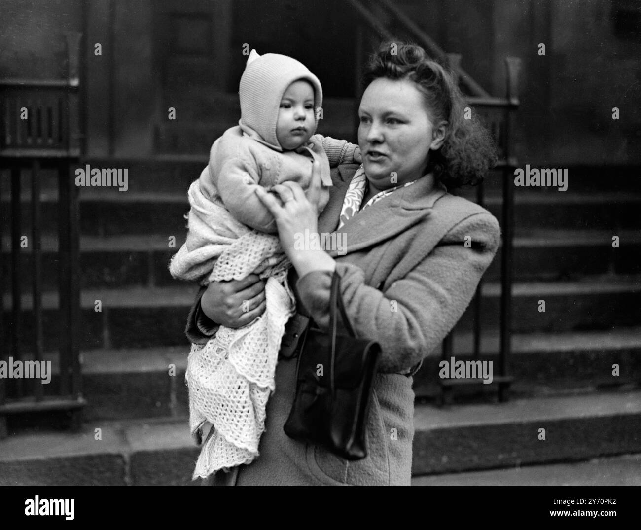 Warmly dressed in a blue woollen suit, seven-months-old Raymond Larry ...