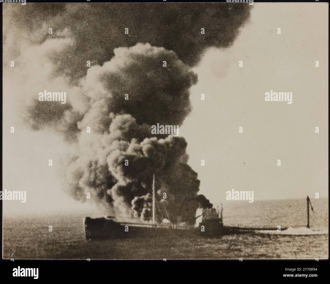 THE END OF A U-BOAT VICTIM.PHOTO SHOWS:- A column of dense black smoke ...