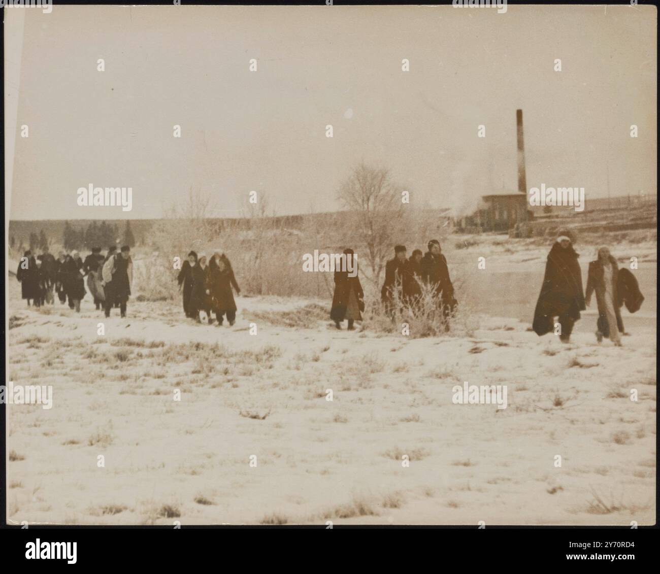 WOMEN HELP WOUNDED MEN TO SHELTER IN AIR RAID.PHOTO SHOWS:- Women ...
