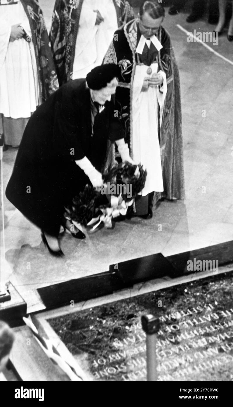 Lady Spencer-Churchill bends to lay a wreath on the commemorative stone ...