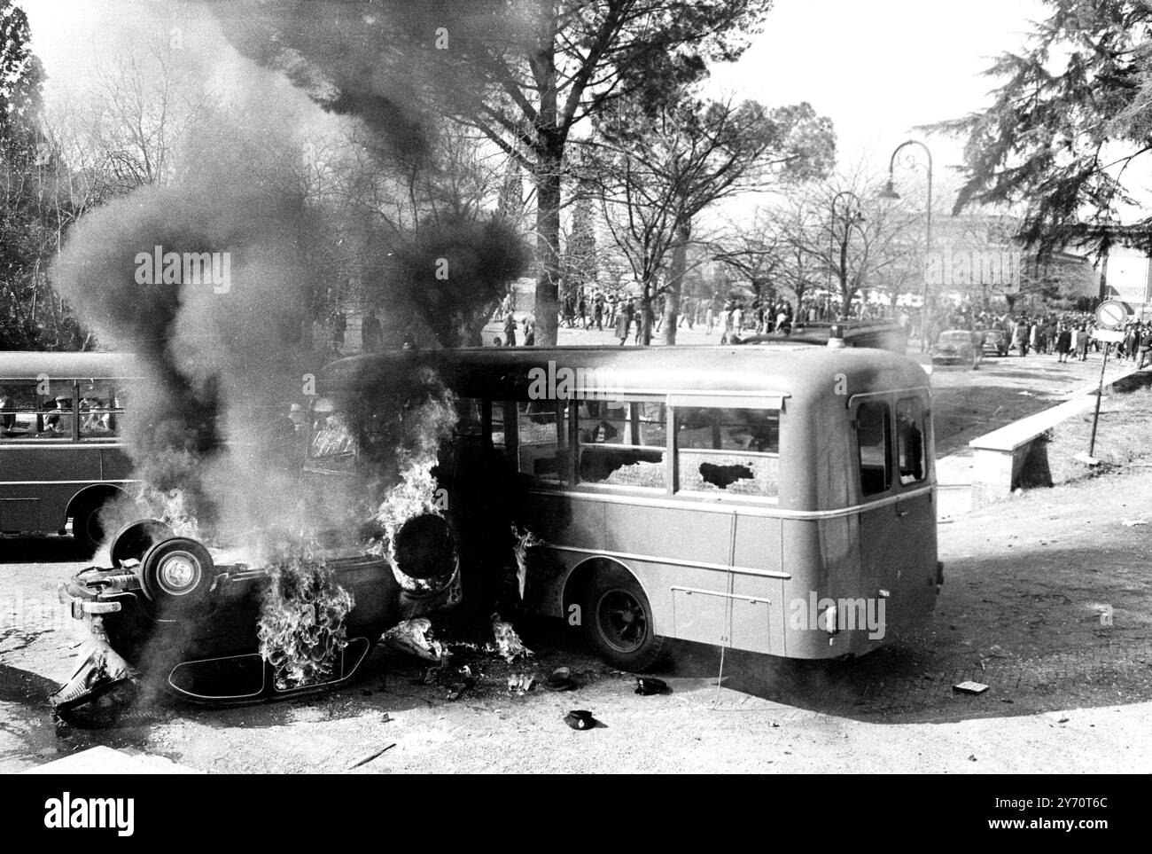 Rome : An overturned police car and a bus burn together after extrrme ...
