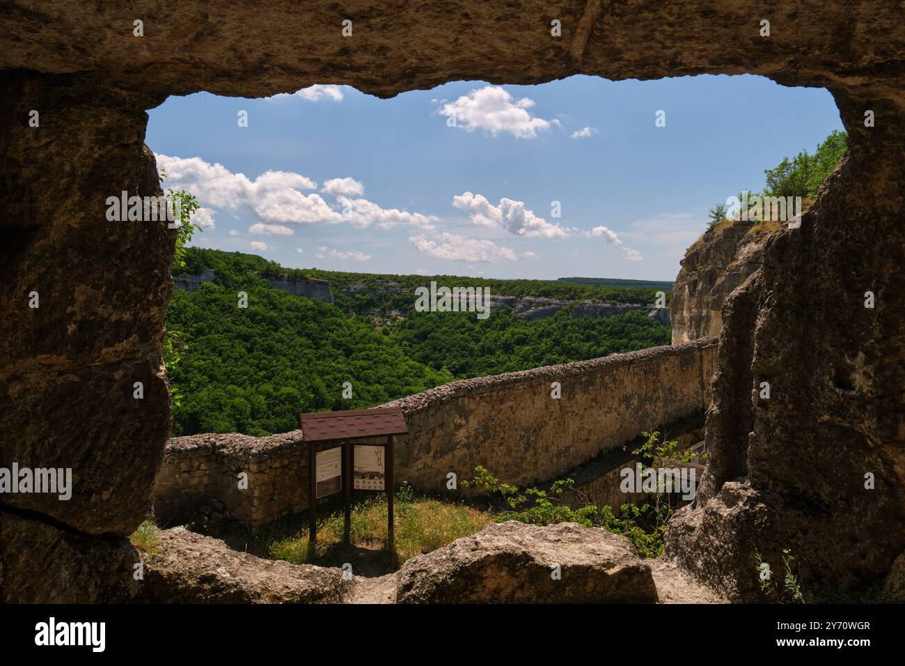 framed by the rocky entrance of an ancient stone structure Stock Photo ...