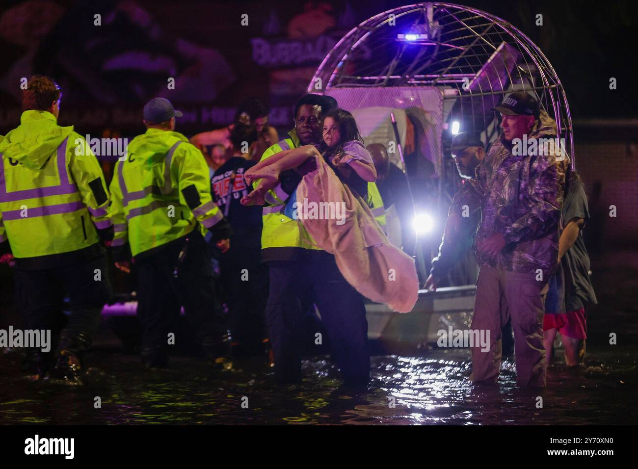 An airboat transports residents rescued from floodwaters in the ...