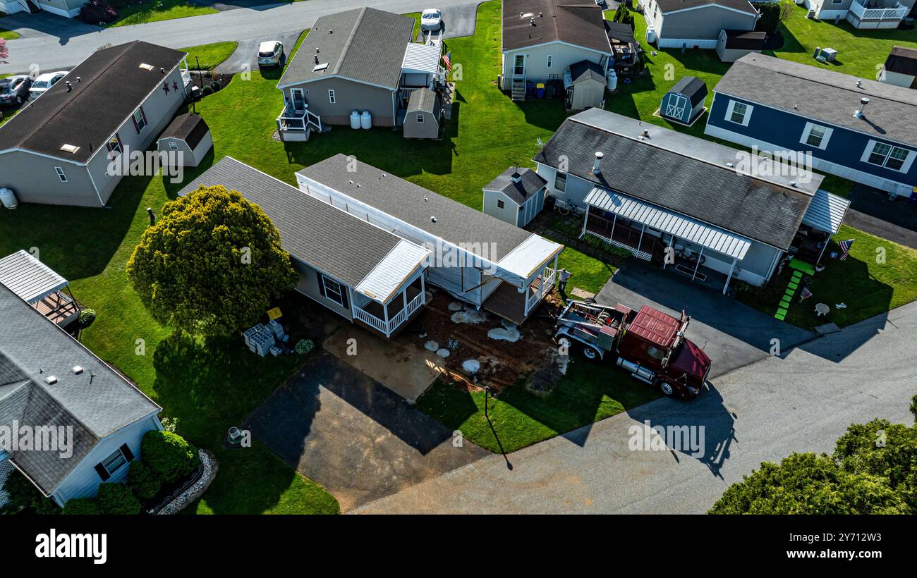 Aerial view shows mobile, manufactured homes lined along a tranquil ...