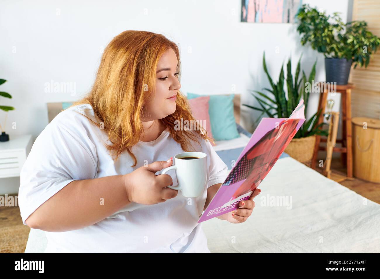 A lovely plus size woman with flowing hair sips coffee and reads a ...