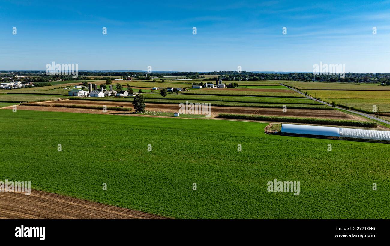 A vast expanse of farmland stretches across the landscape, featuring ...