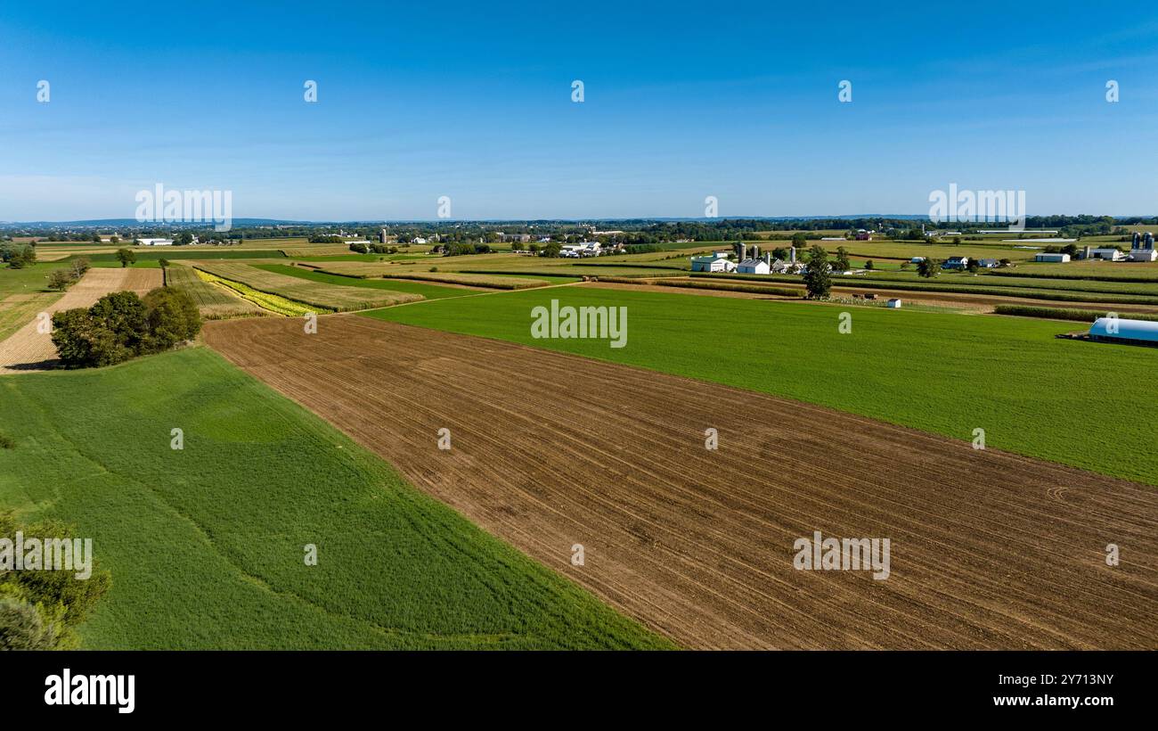 A vast expanse of farmland stretches across the landscape, featuring ...