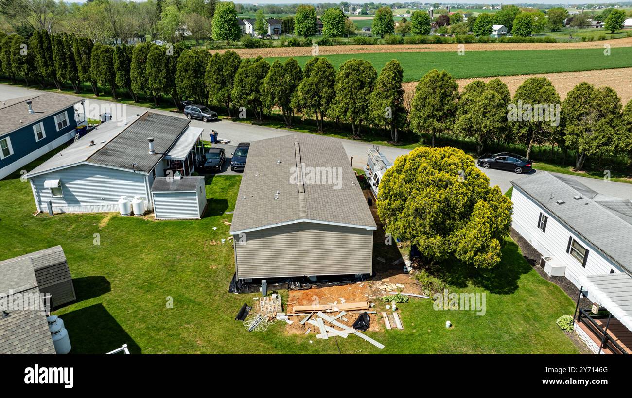 Aerial view shows mobile, manufactured homes lined along a tranquil ...