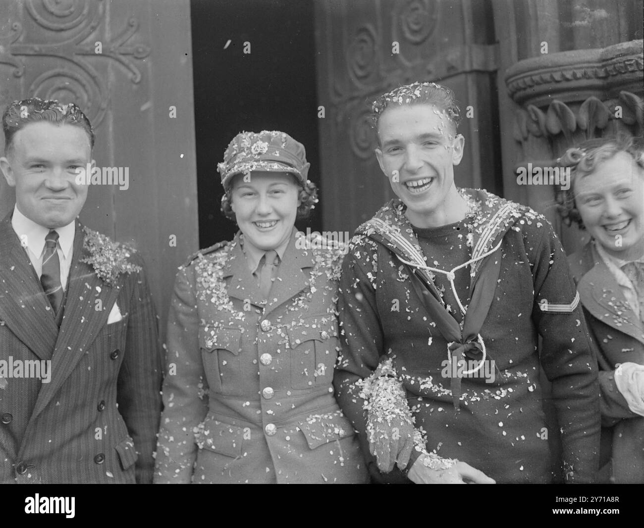 Wedding Navy rating and ATS girl both in uniform. Lots of confetti om ...