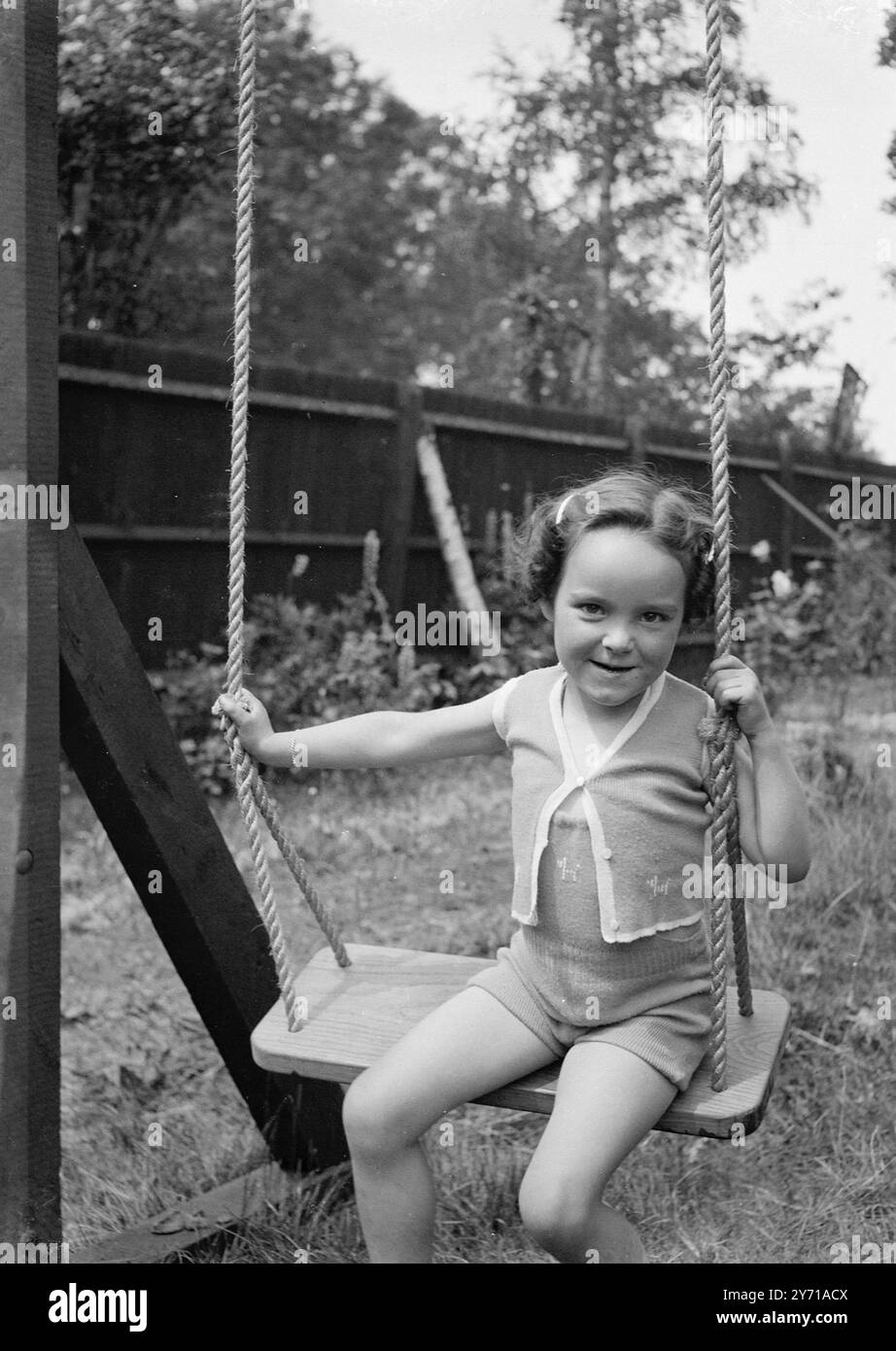 Sitting on swing Black and White Stock Photos & Images - Alamy