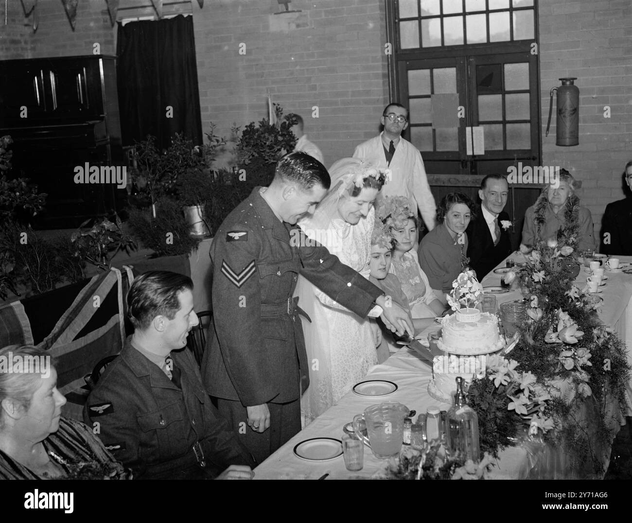 Wedding - R.A.F.interior of hall. Wedding cake about to be cut, bride ...
