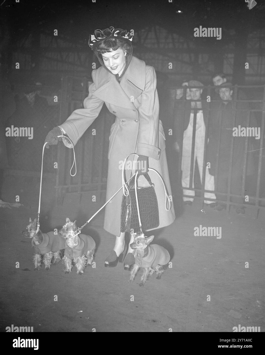 WITH DOGS TO MATCH Mrs. OLIVE LARKIN , in a striking hat style and with ...