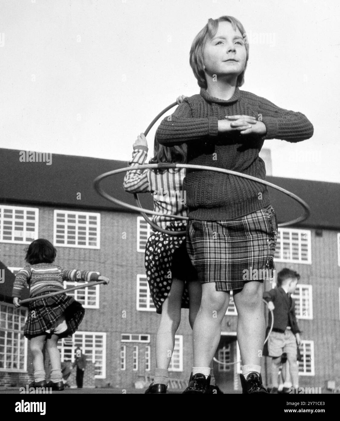 Children playing with Hula Hoops in the school playground Stock Photo ...