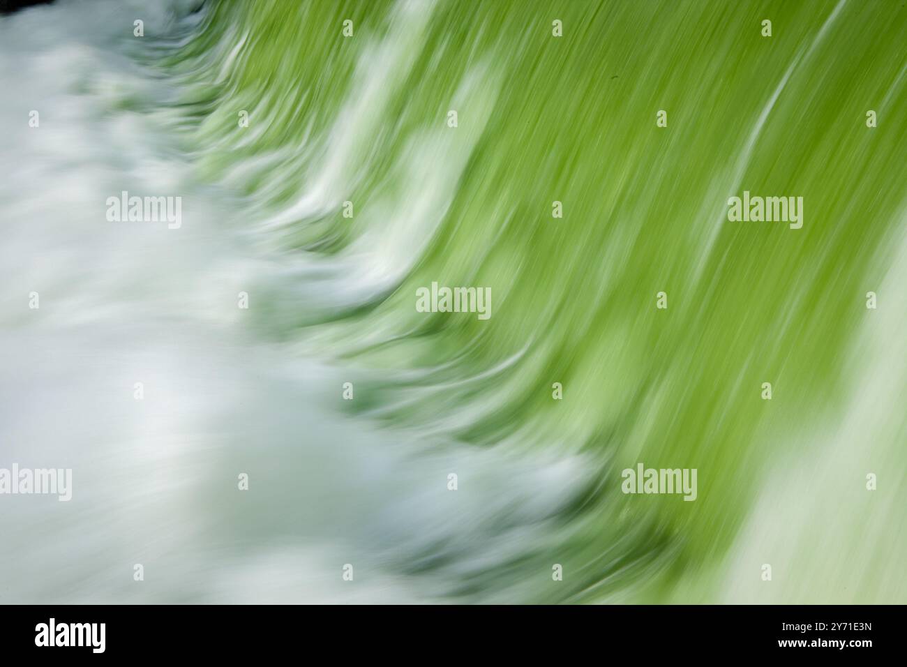 Abstract photograph of water cascading over a weir, creating a ...