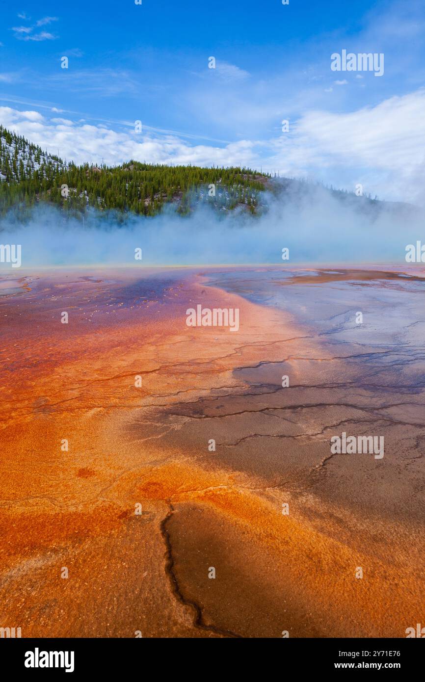 Steam is rising from the grand prismatic spring in yellowstone national ...
