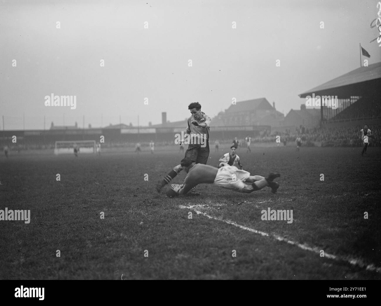 OLDHAM DIVES.TO SAVEJONES. Oldham Goalkeeper, dives at the feet of J ...