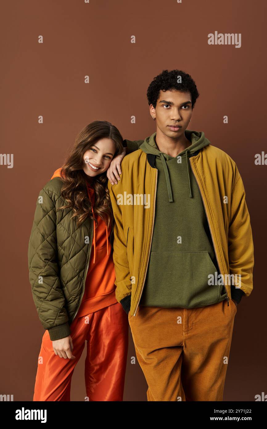 A fashionable couple showcases their trendy autumn styles with cheerful ...