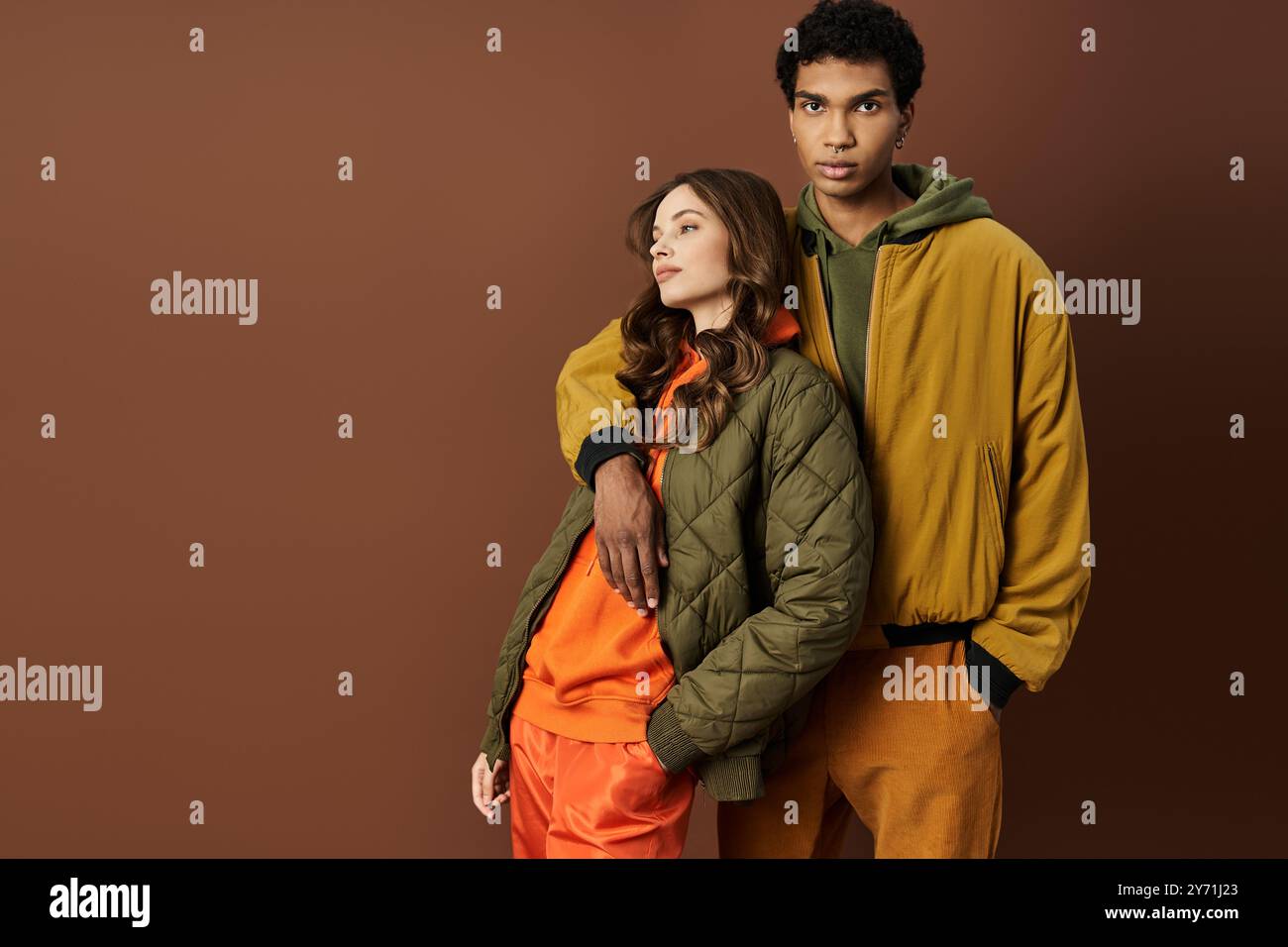 A stylish couple showcases their trendy autumn outfits in rich, warm ...