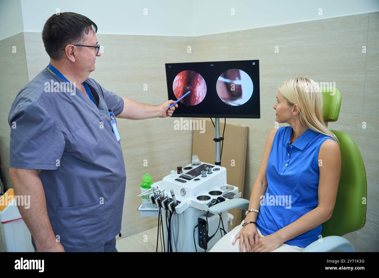 Doctor showing ear scan images to patient Stock Photo - Alamy
