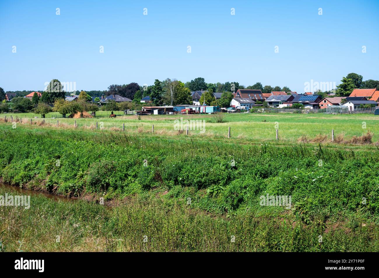 Green meadow and house backyards at the Flemish countryside in Halen ...