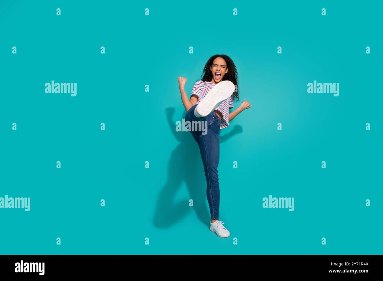 Full size photo of pretty young girl kick leg scream fighting wear ...