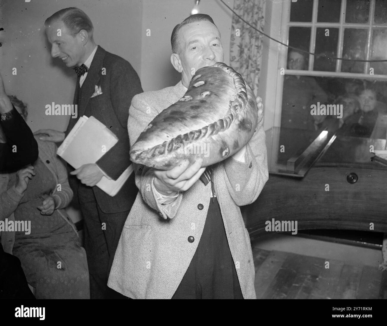 WILFRED HAS A GO WILFRED PICKLES tackles an out size in Cornish pasties ...