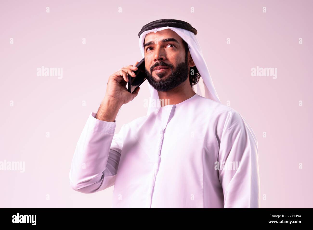 Arab businessman wearing emirati kandura portrait in studio in Dubai ...