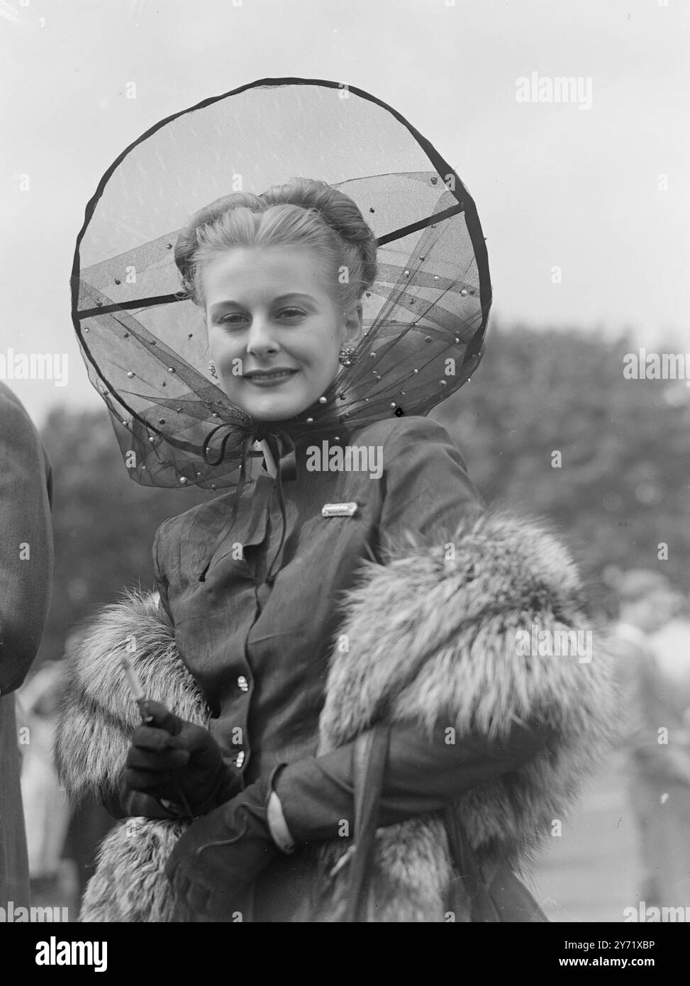 "Upper Circle" - At Theatrical Garden Party. Smiling Andrea Lea, wears a transparent circle for ...