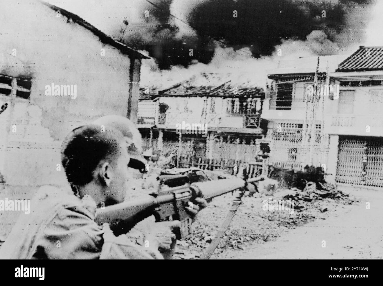 Saigon: Outnumbered South Vietnamese rangers advance through the burning Cholon sector of the ...
