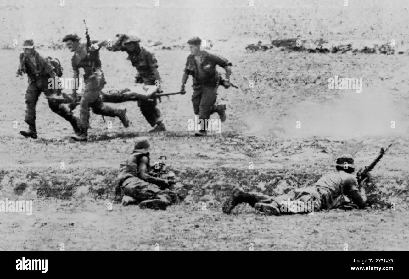 Saigon : Members of the 25th US Infantry carry a wounded GI to a ...