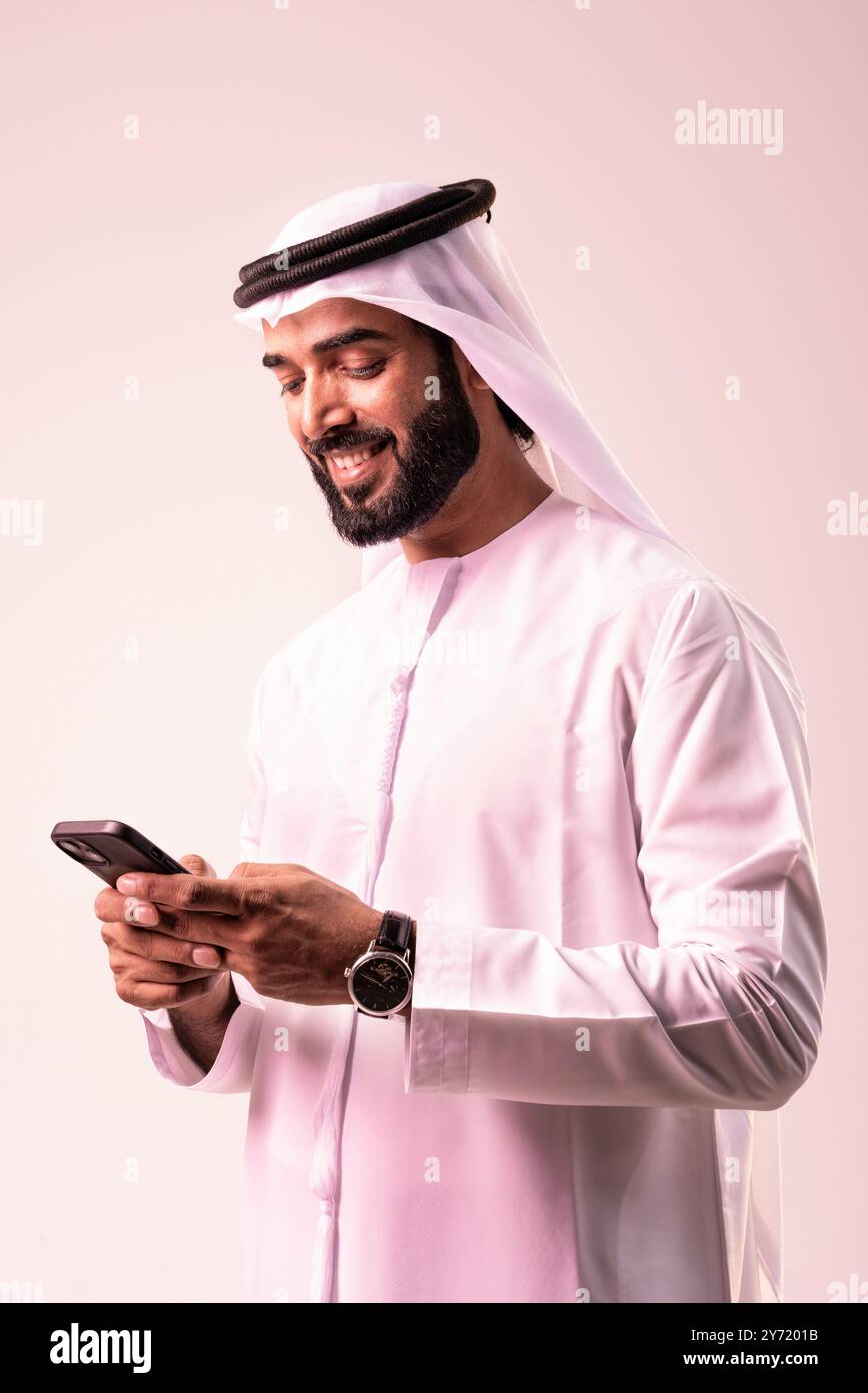 Arab businessman wearing emirati kandura portrait in studio in Dubai ...