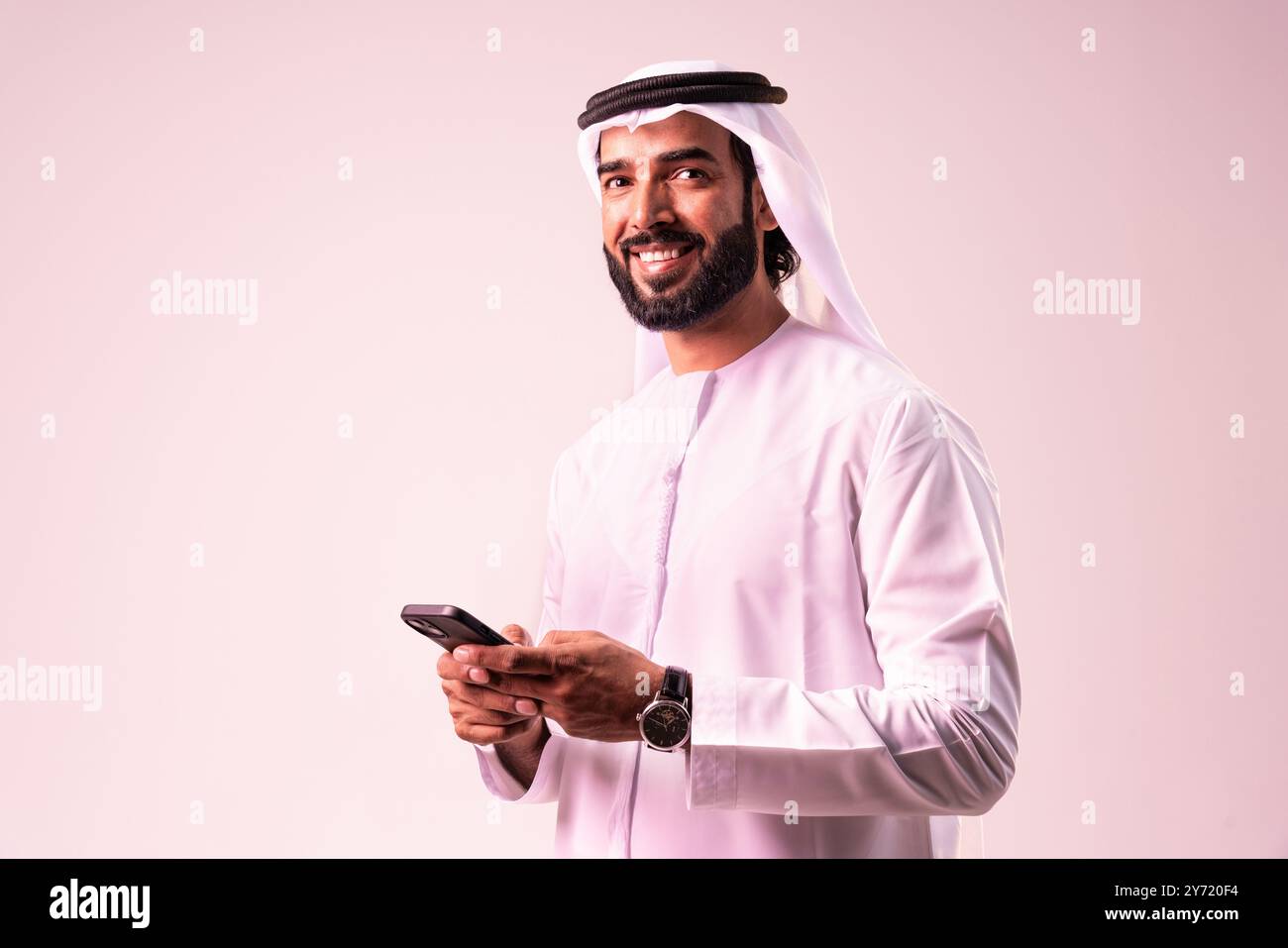 Arab businessman wearing emirati kandura portrait in studio in Dubai ...