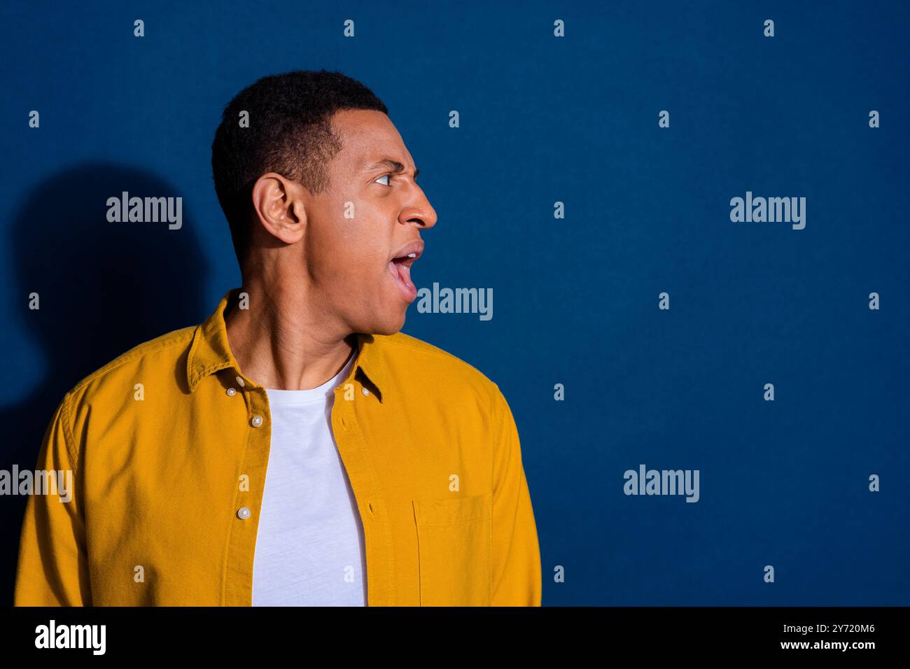 Photo of aggressive young guy wearing stylish shirt angry screaming mad ...