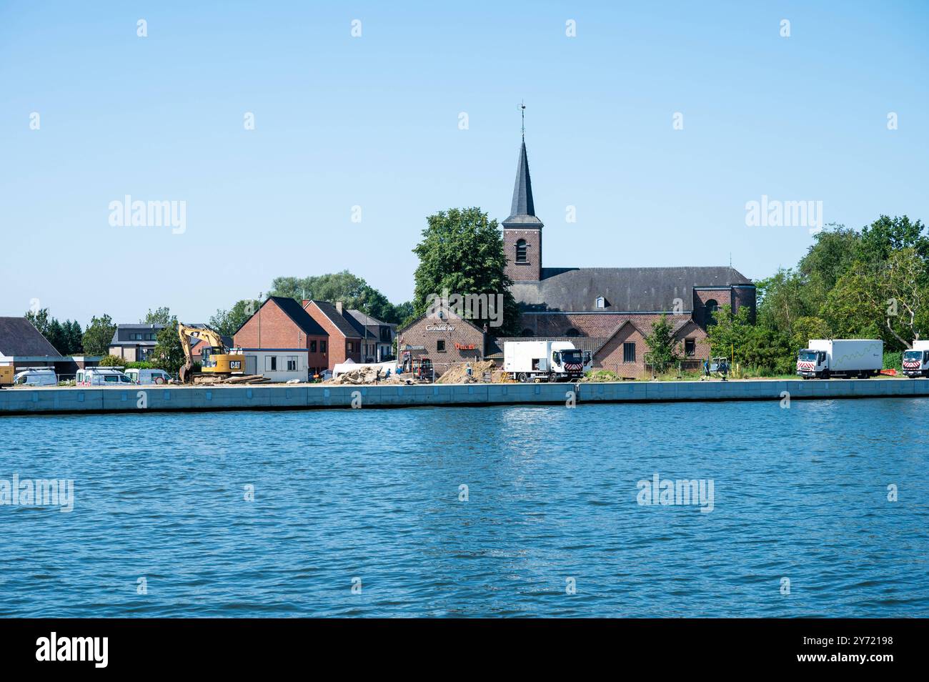 Stokrooie, Hasselt, Belgium, AUG 12, 2024 View over the village church at the banks of the ...
