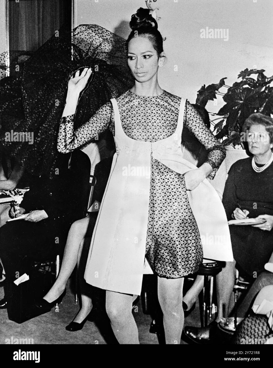 Tiziani designs A black veiling headpiece , seen in model 's hand ...