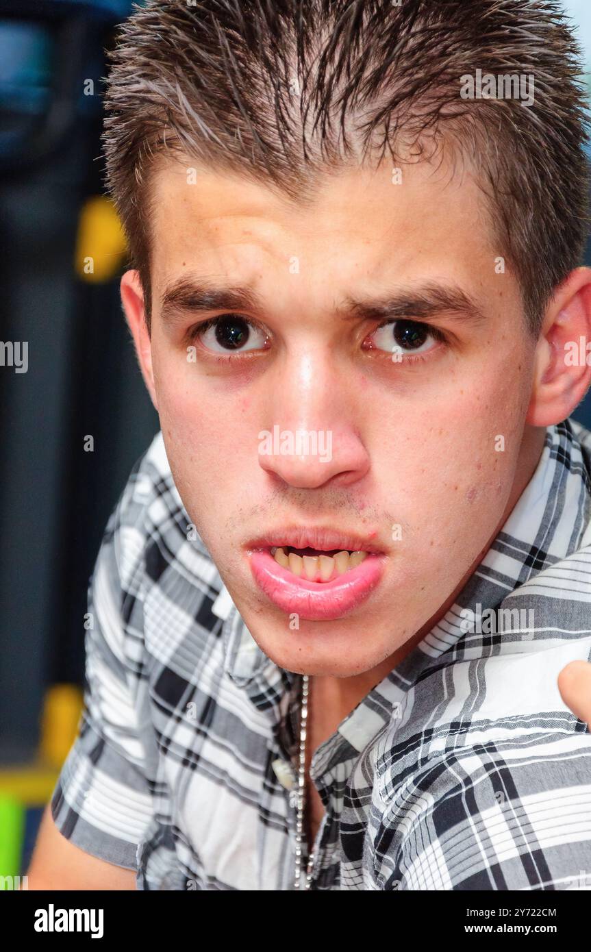 Teenager boy making a monkey face Stock Photo - Alamy