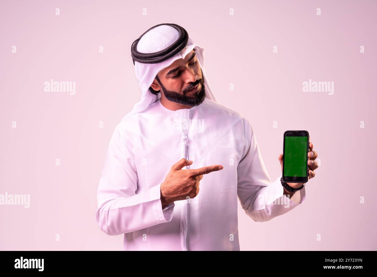 Arab businessman wearing emirati kandura portrait in studio in Dubai ...