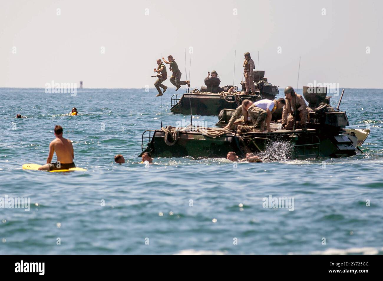 U.S. Marines with 3rd Assault Amphibian Battalion, jump from an ...
