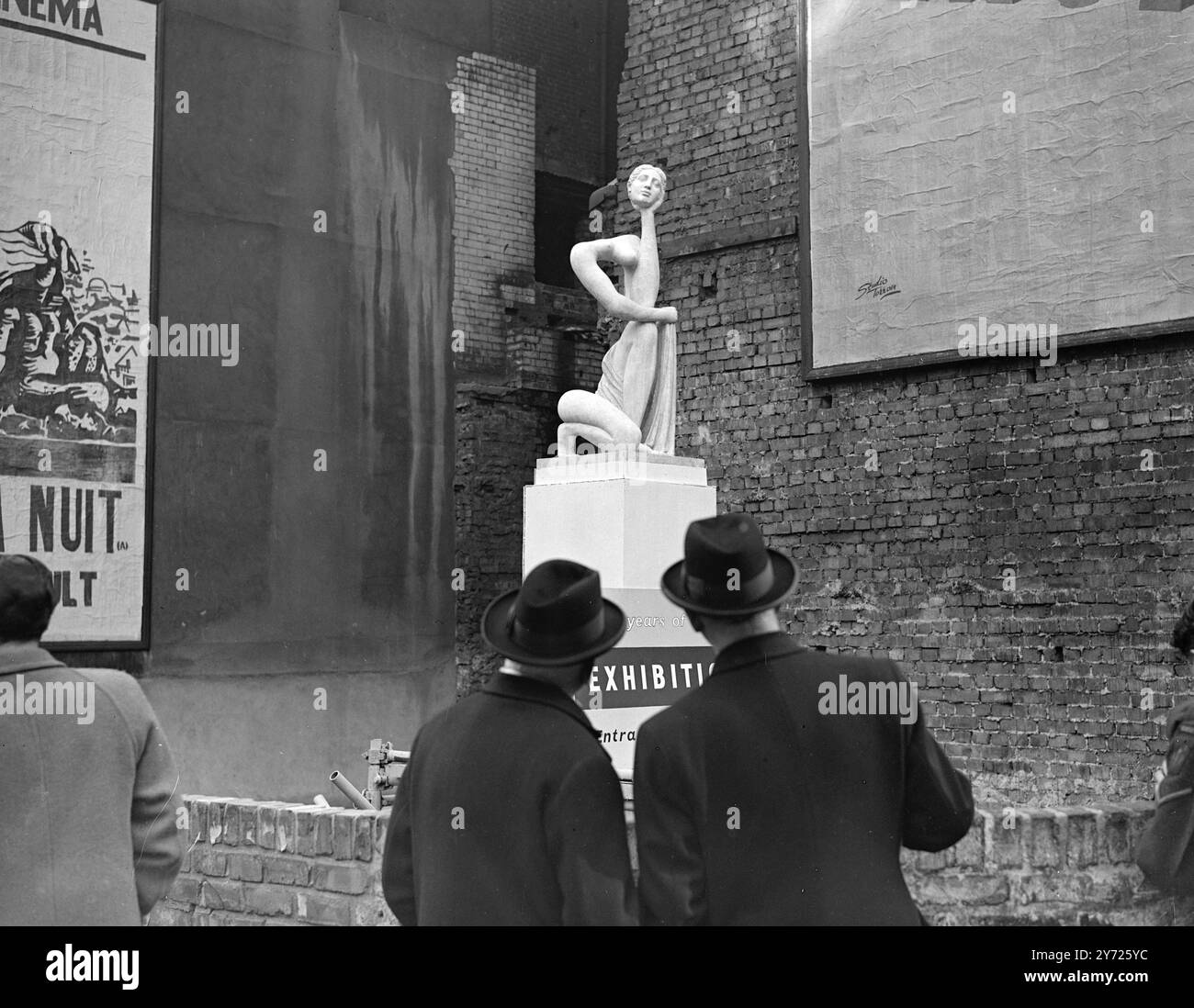 Passers-by looking at the surrealist sculpture made by F.E.McWilliams ...