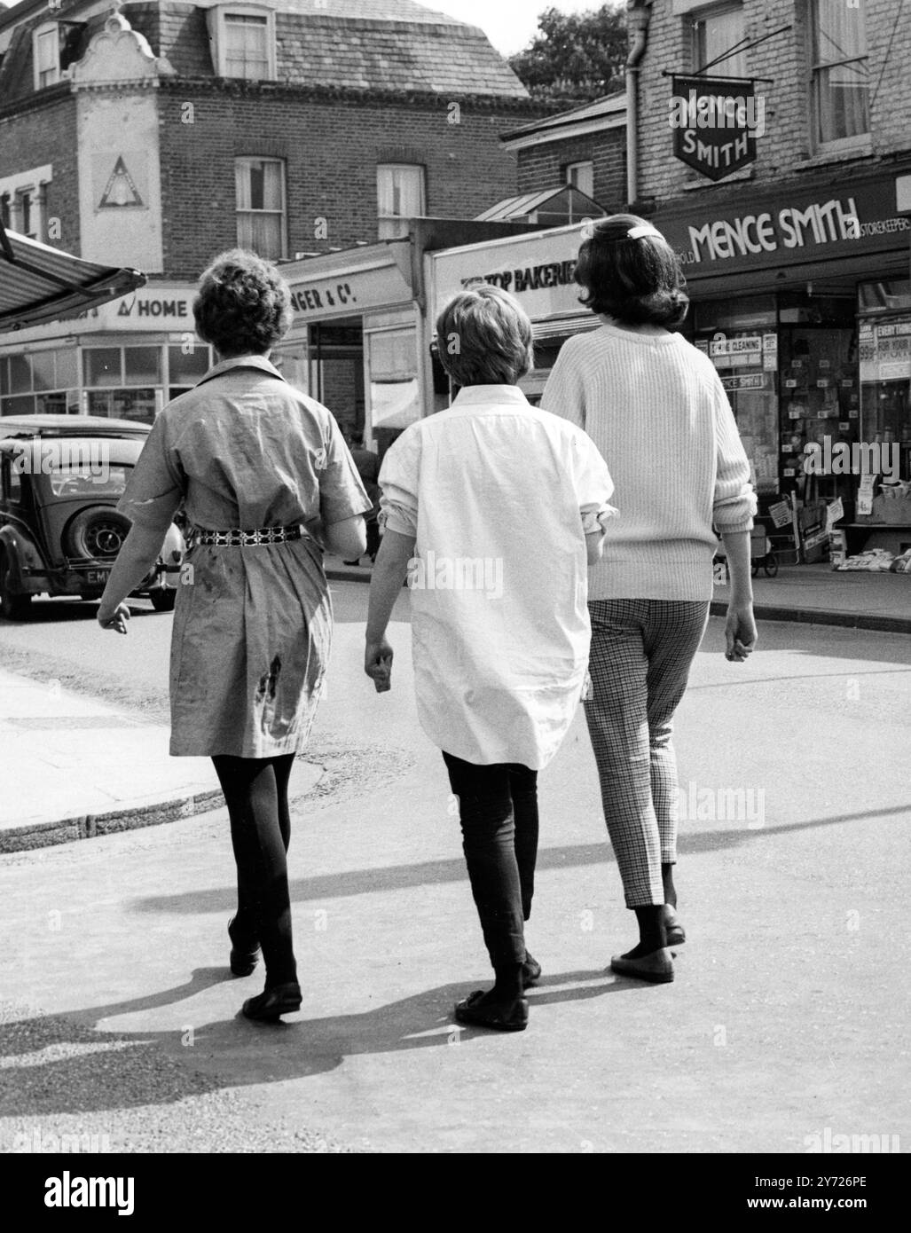 Three young women ( artists ) walking down Sidcup High Street, in Kent ...