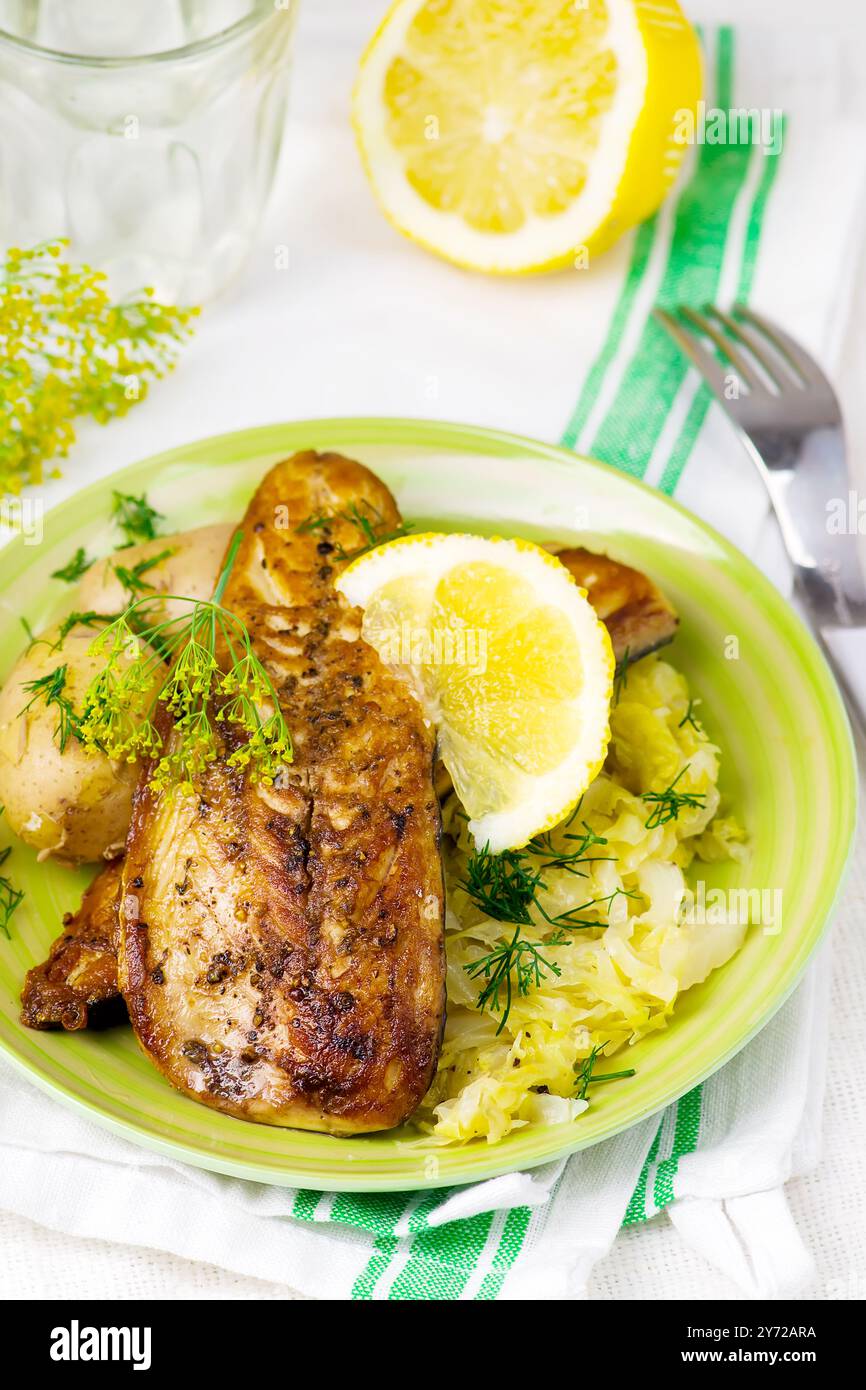 fried mackerel with braised cabbage and potato Stock Photo - Alamy